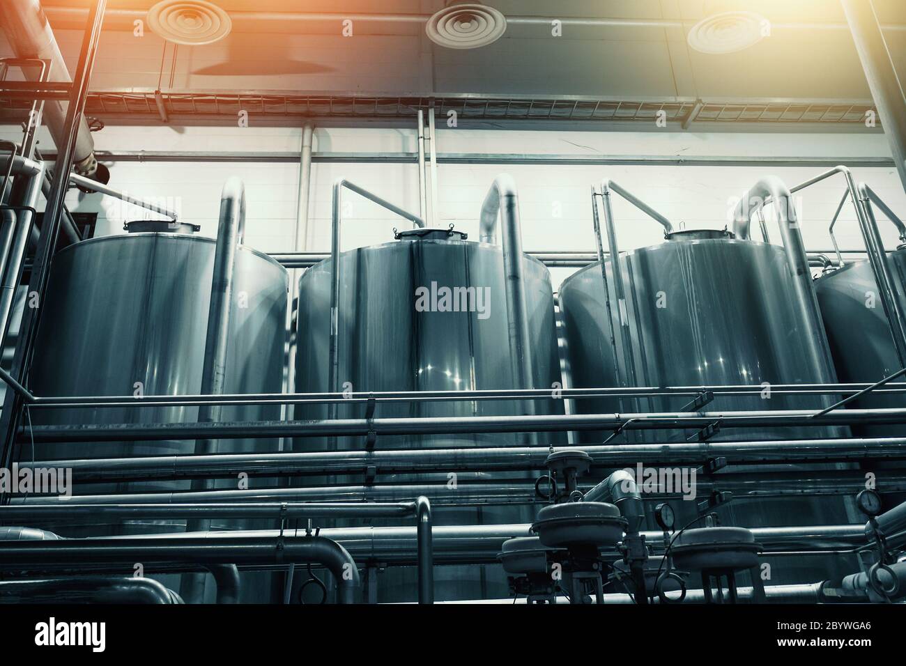 Large steel industrial stainless steel vats in modern brewery, toned ...