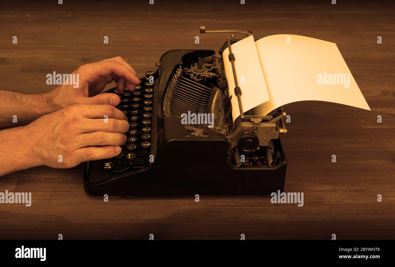 Writer or reporter behind the typewriter Stock Photo - Alamy