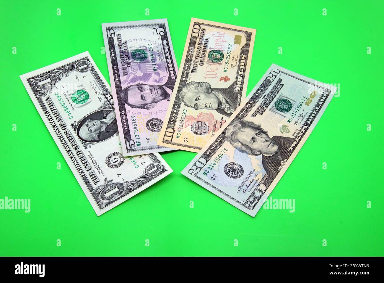 Banknotes in denominations of 1, 5, 10 and 20 dollars in a bright green ...