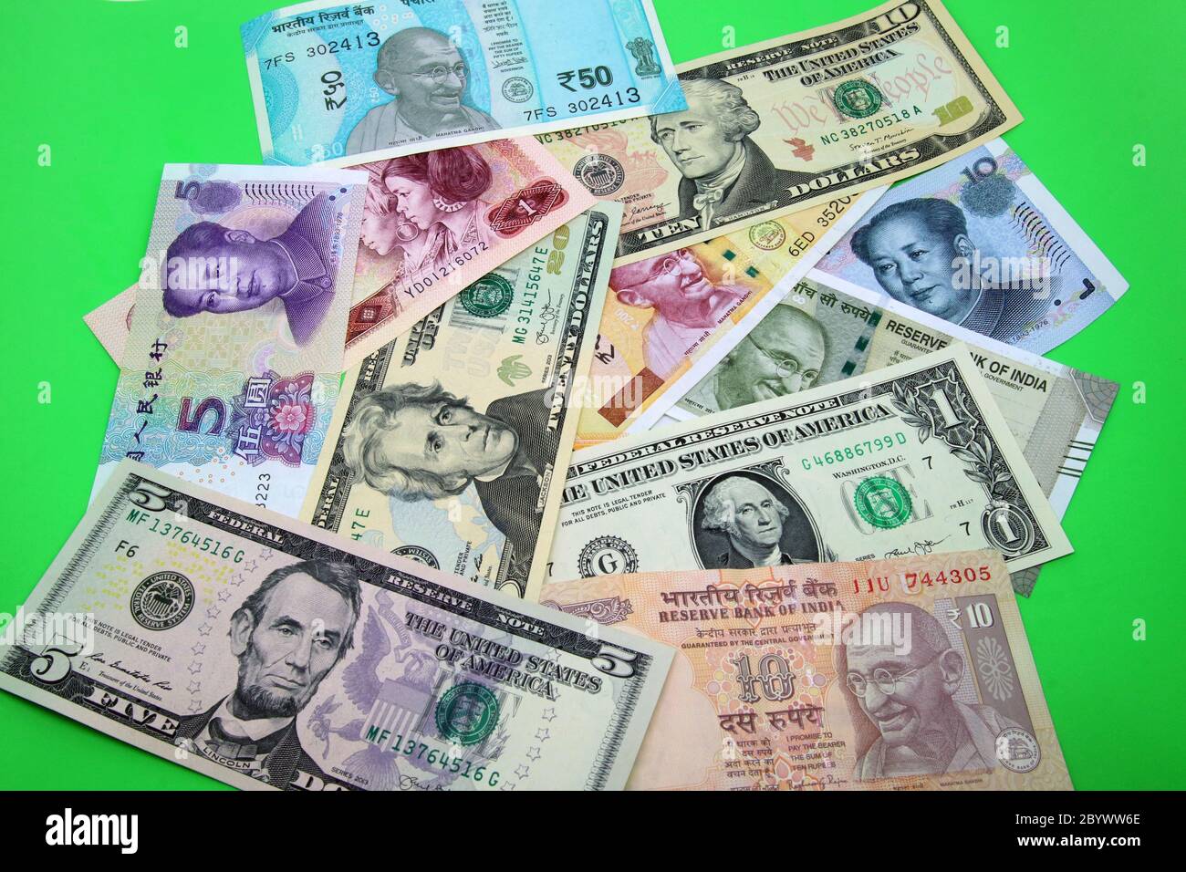 Mix of American, Chinese and Indian colorful banknotes in a bright ...