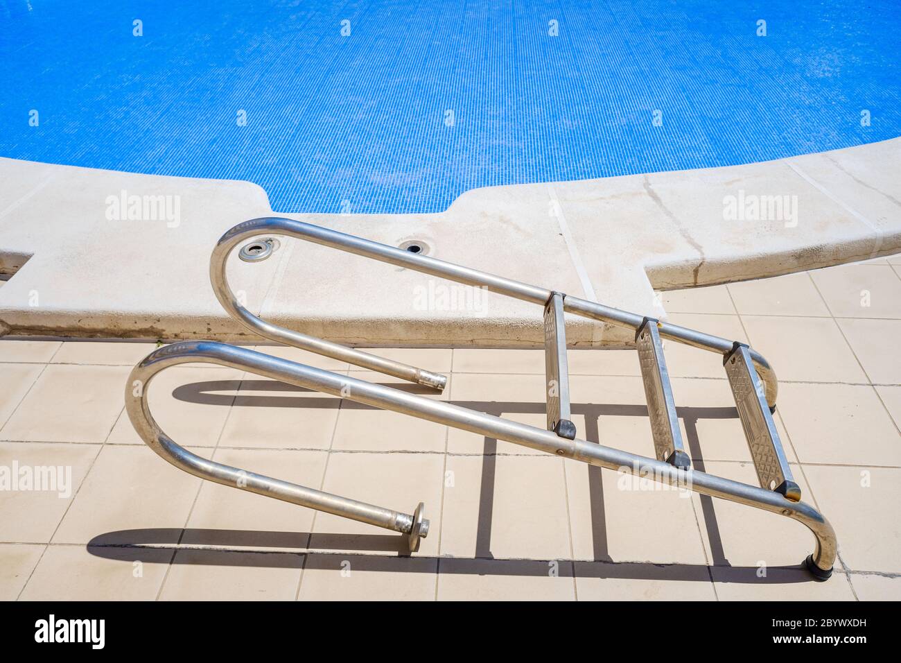 Pool ladder out of the water during repairs Stock Photo - Alamy
