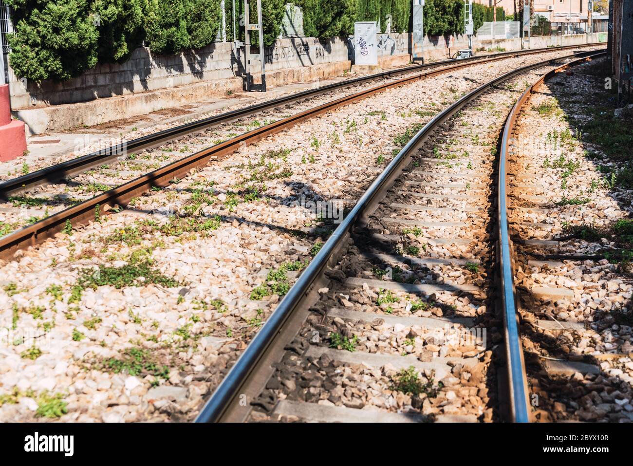 Two curved train tracks in a turn within a village Stock Photo - Alamy