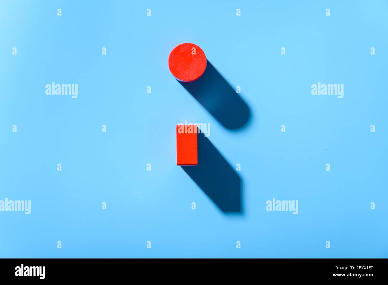 Long shadow cast by two red blocks on a light blue background, copy ...