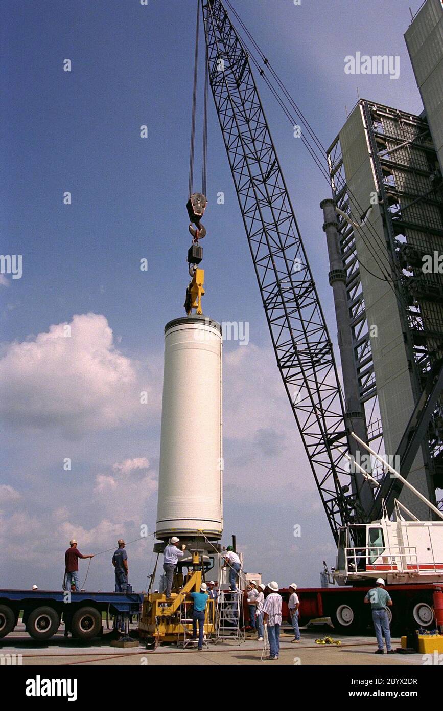 Workers erect the first stage of a Lockheed Martin Launch Vehicle-2 ...
