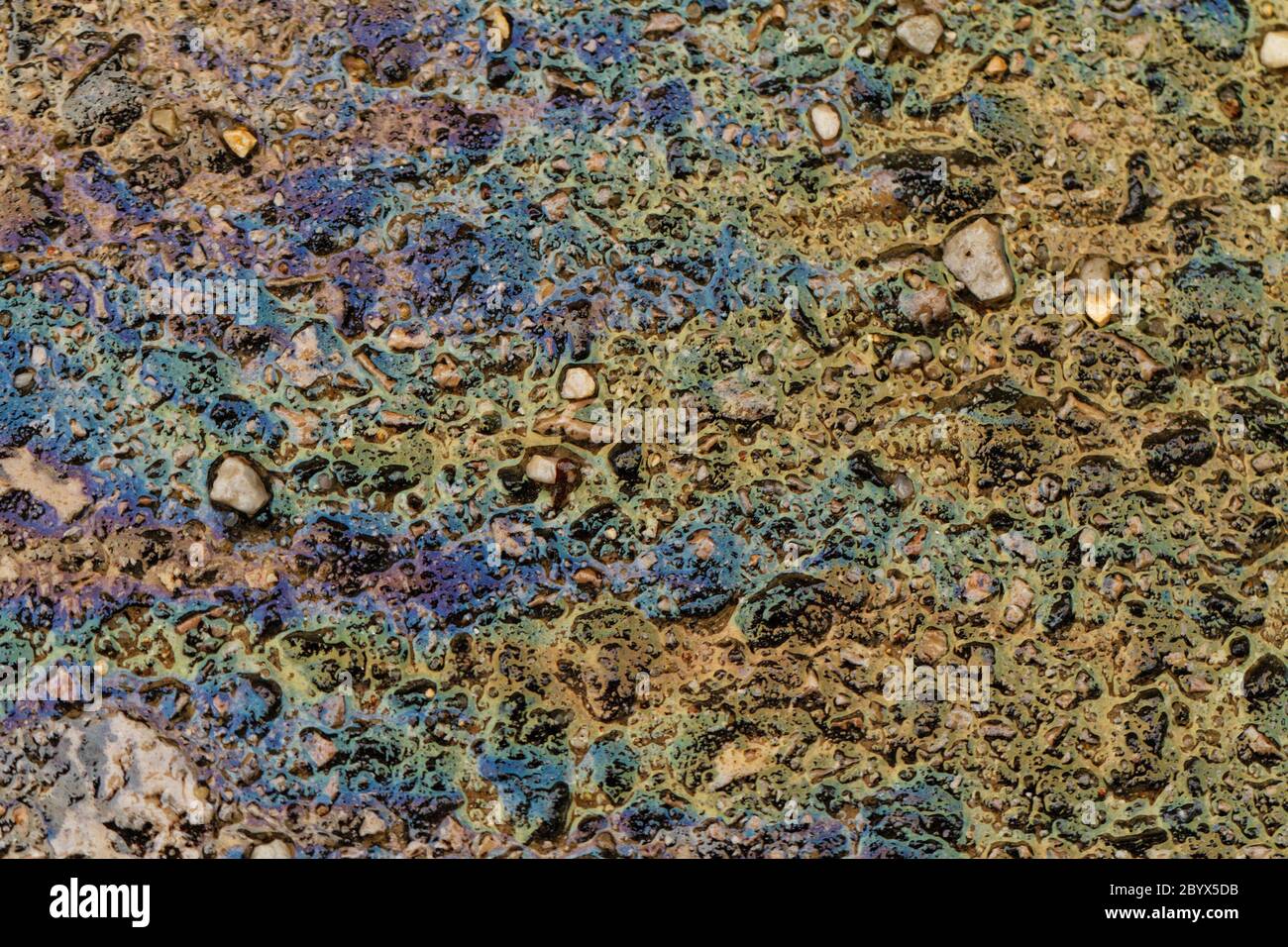 Photo of colorful oil spill on the road Stock Photo - Alamy