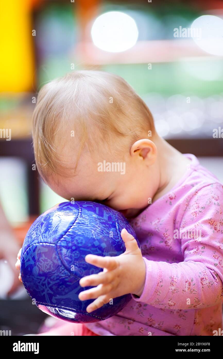 Cute little baby playing with a ball Stock Photo - Alamy