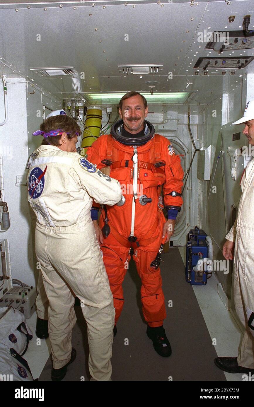 STS-85 Commander Curtis L. Brown, Jr., is assisted with his ascent ...