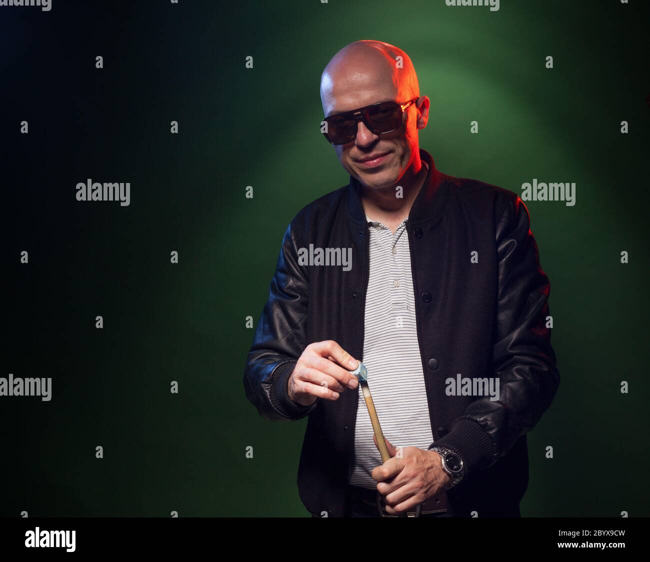 Trendy dude playing a game of pool in a nightclub Stock Photo - Alamy
