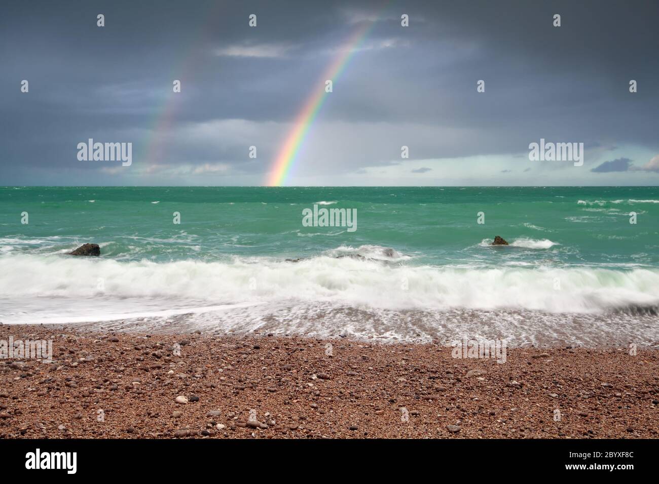 beautiful rainbow over ocean coast Stock Photo - Alamy