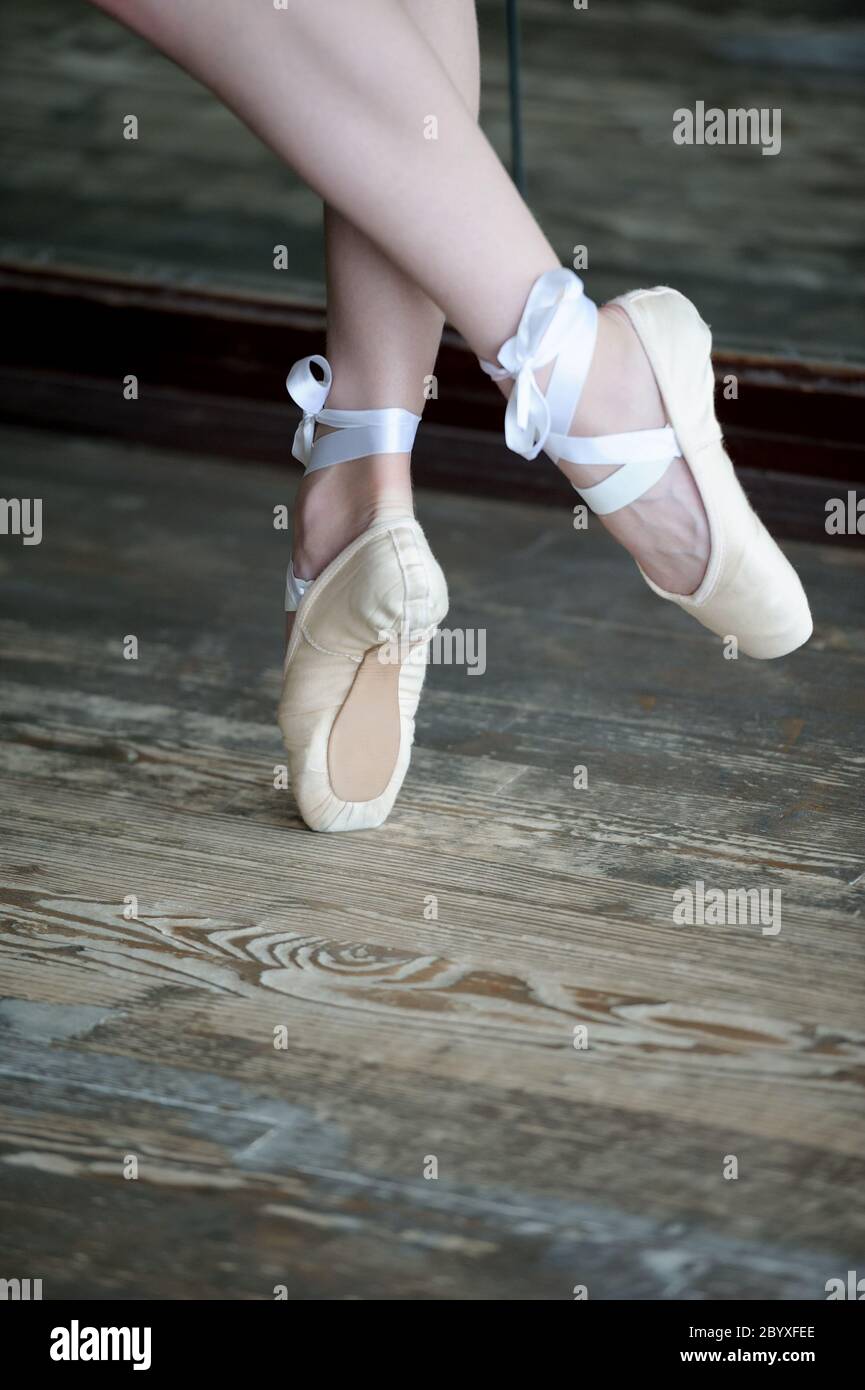 Dancing feet in ballet shoes on wooden floor Stock Photo - Alamy