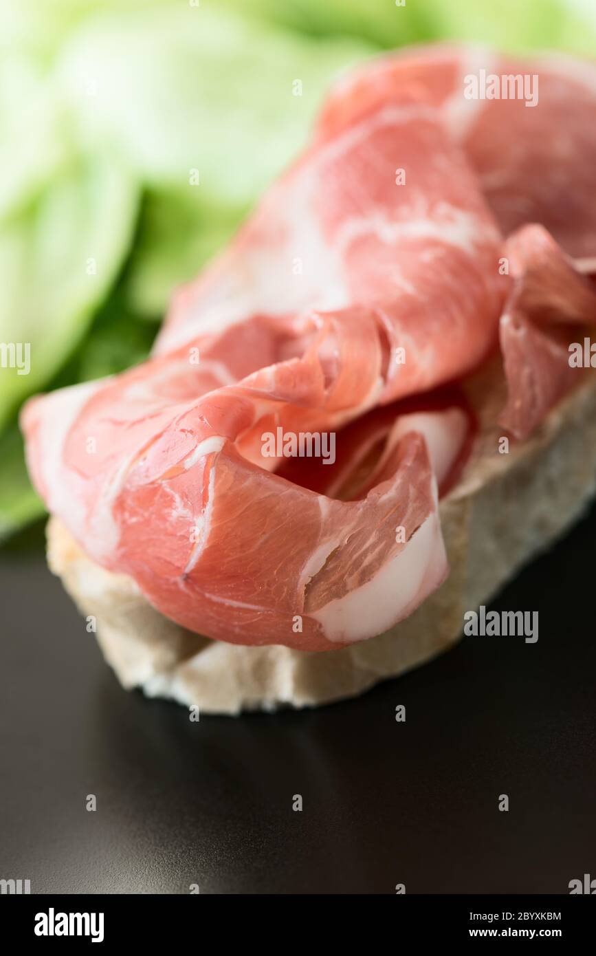 Ham Sandwich on black plate vertical Stock Photo - Alamy