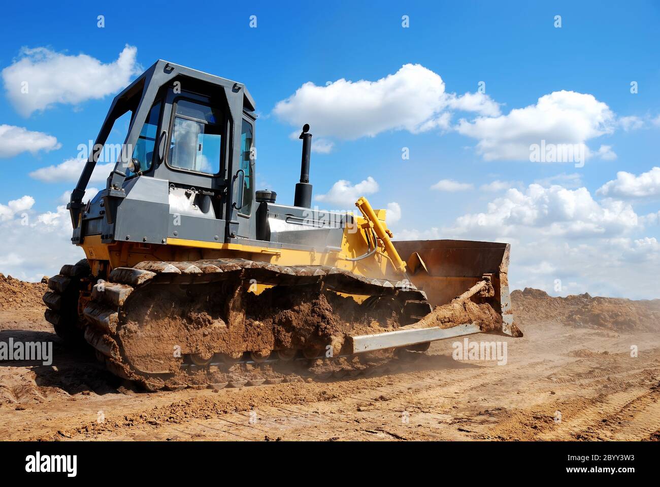 bulldozer with raised blade in action Stock Photo - Alamy