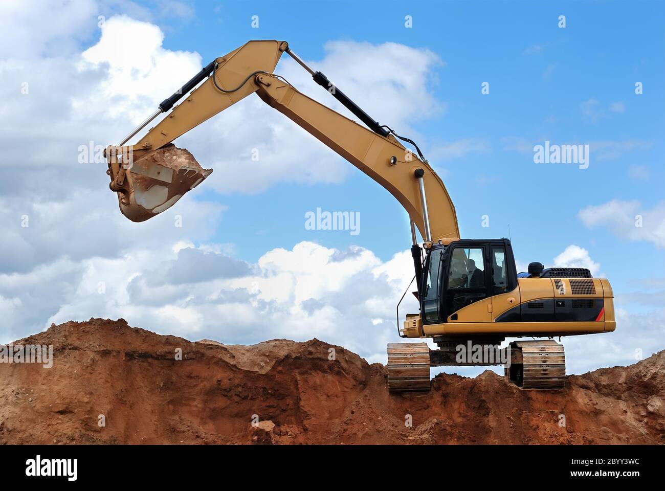 excavator with raised bucket Stock Photo - Alamy