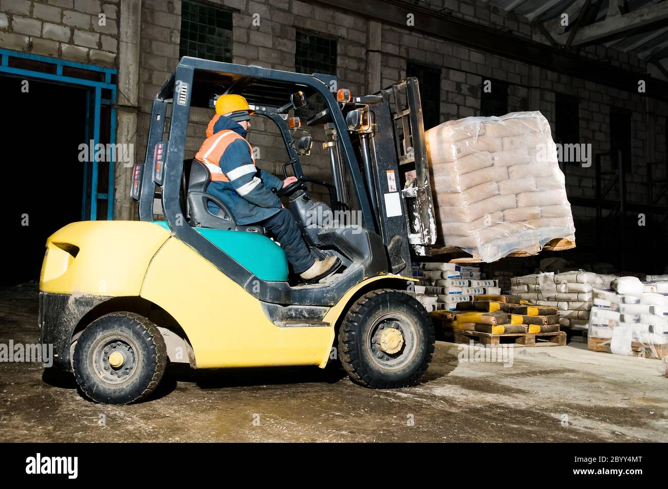 warehouse forklift loader works Stock Photo - Alamy