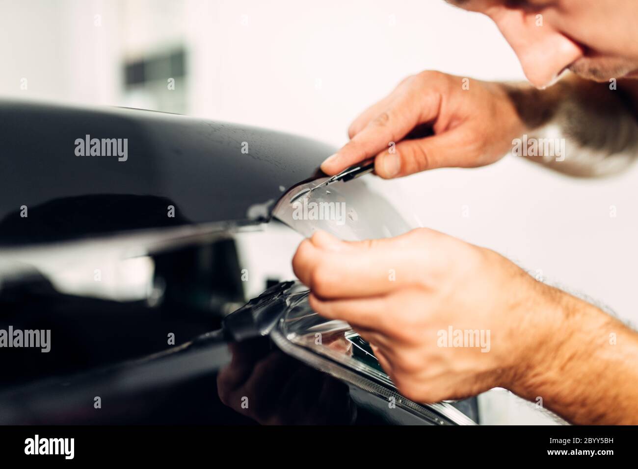 Professional worker install paint protect. Transparent protection film ...