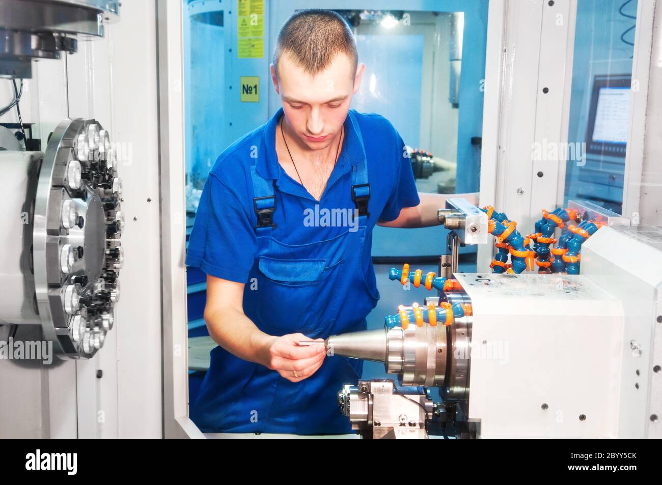 worker operating CNC machine center Stock Photo - Alamy