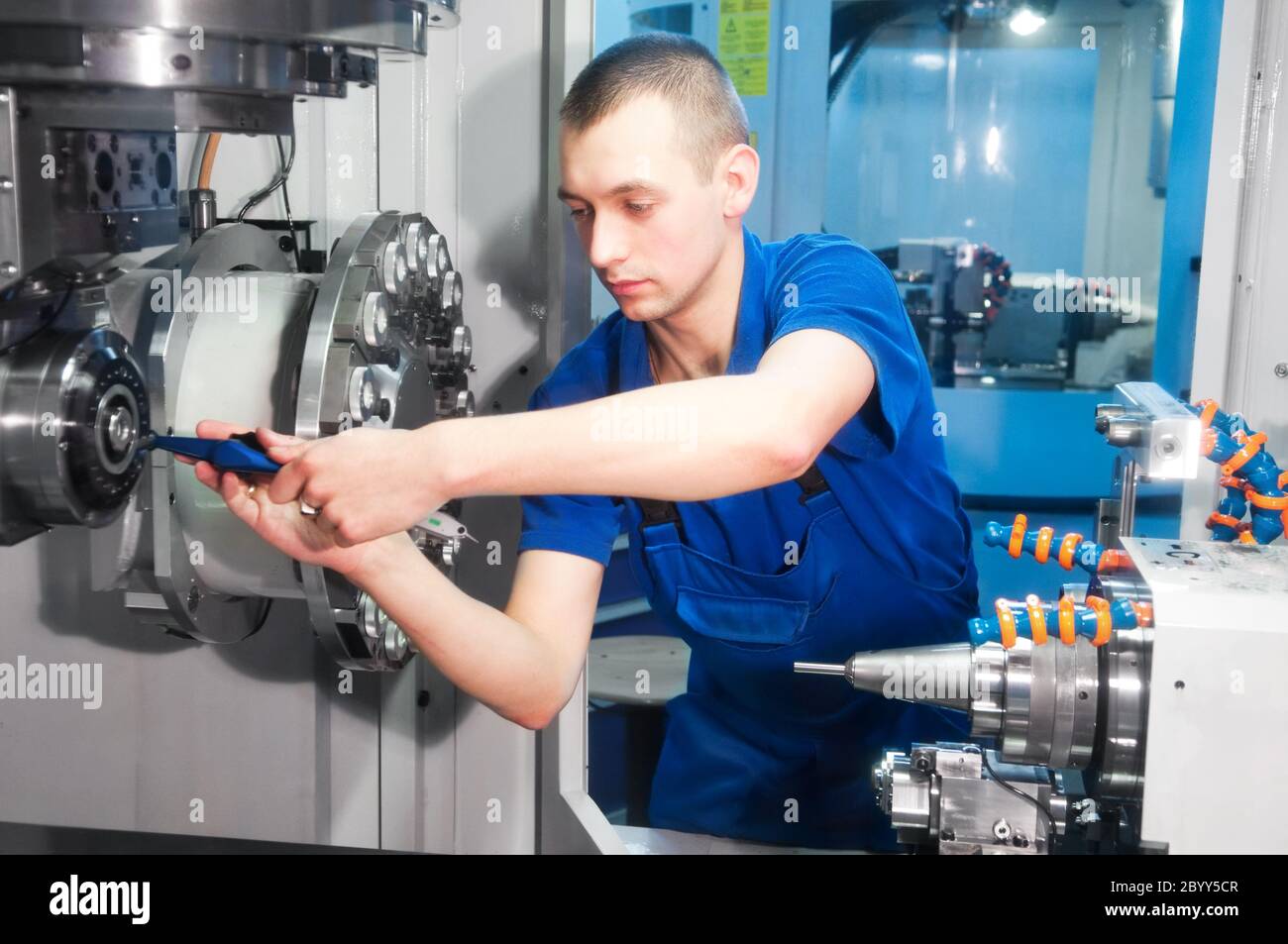 worker operating CNC machine center Stock Photo - Alamy