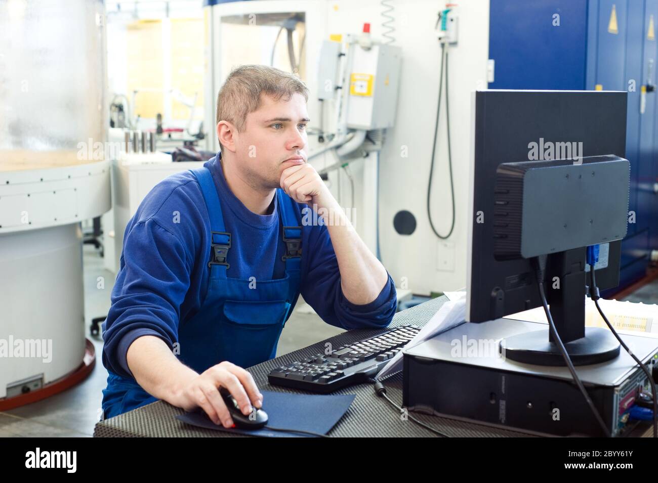 worker operating CNC machine center Stock Photo - Alamy