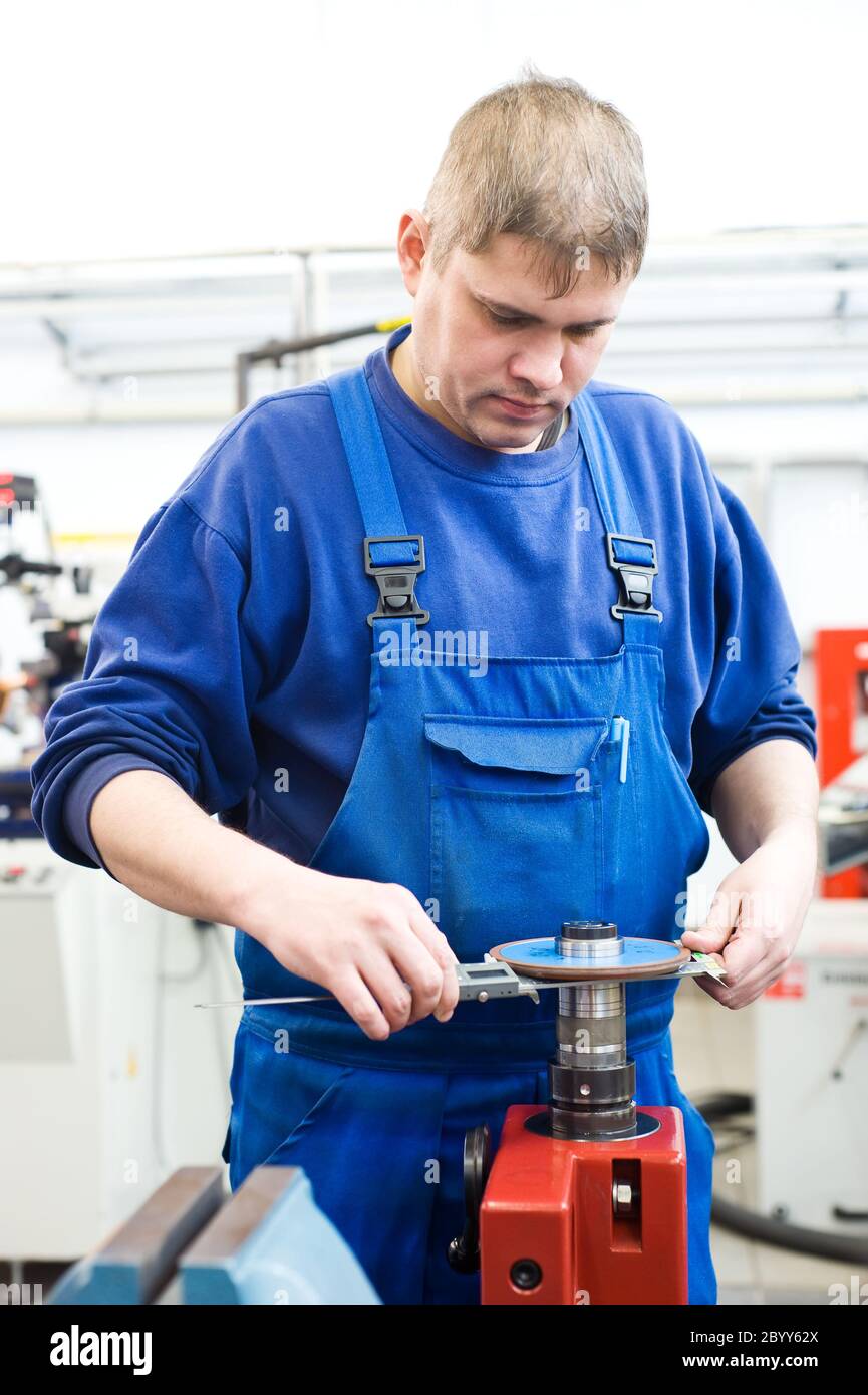 worker checking cutting tool Stock Photo - Alamy