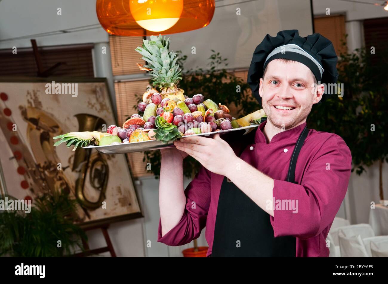 Cheerful chef cook with fruits Stock Photo - Alamy