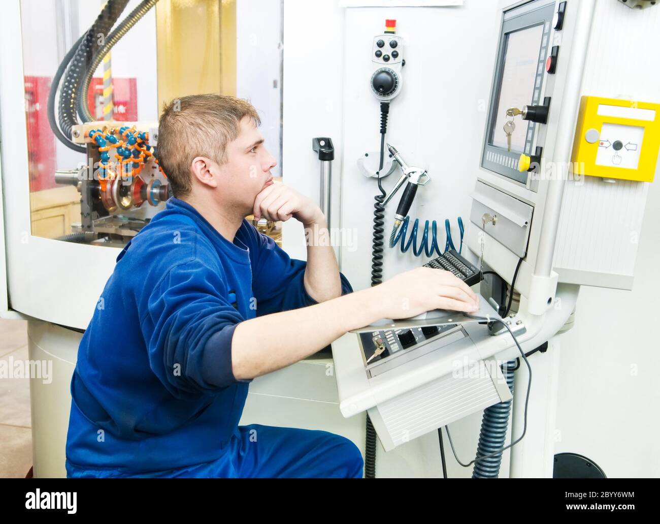 worker operating CNC machine center Stock Photo - Alamy