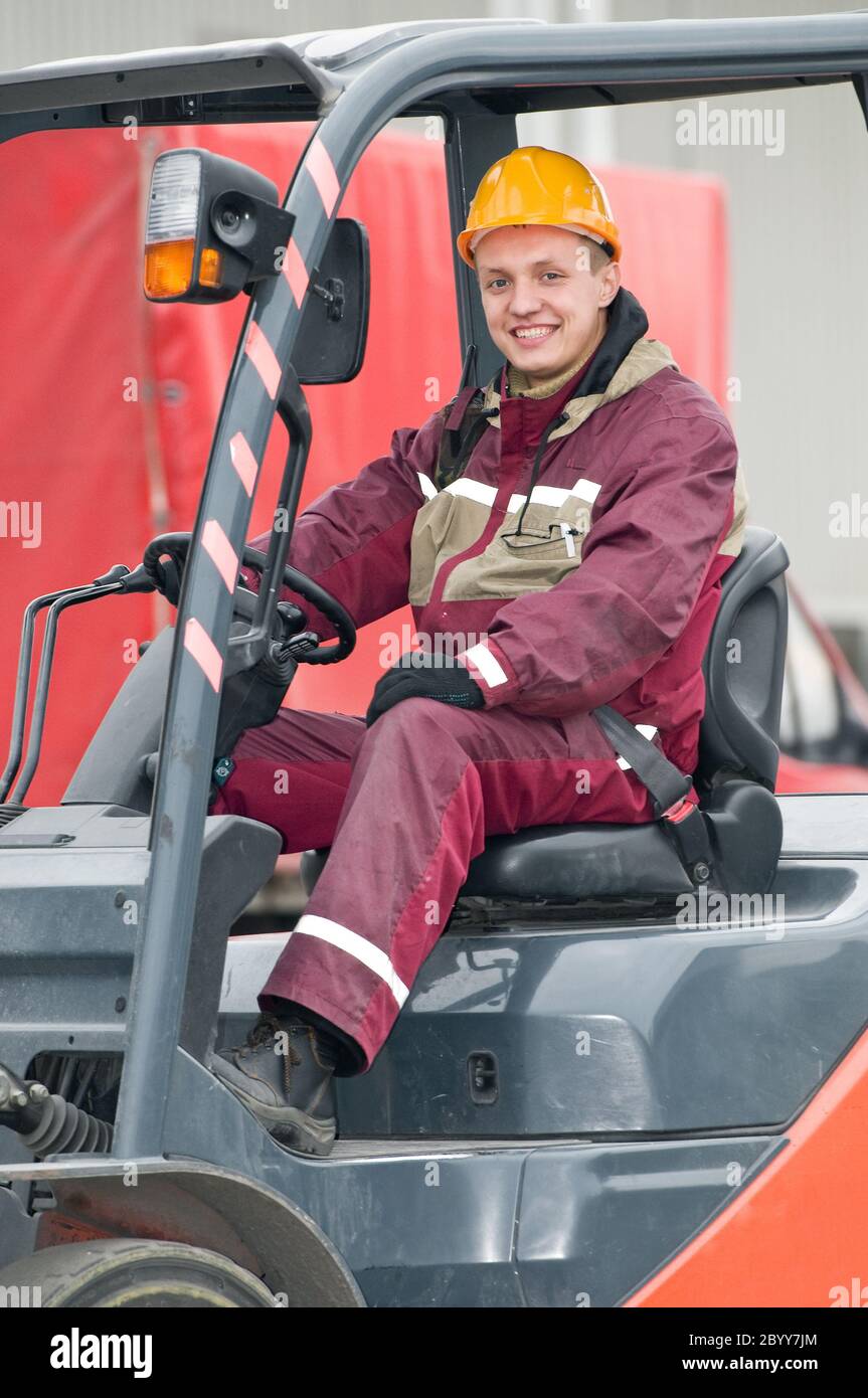 warehouse worker driver in forklift Stock Photo - Alamy