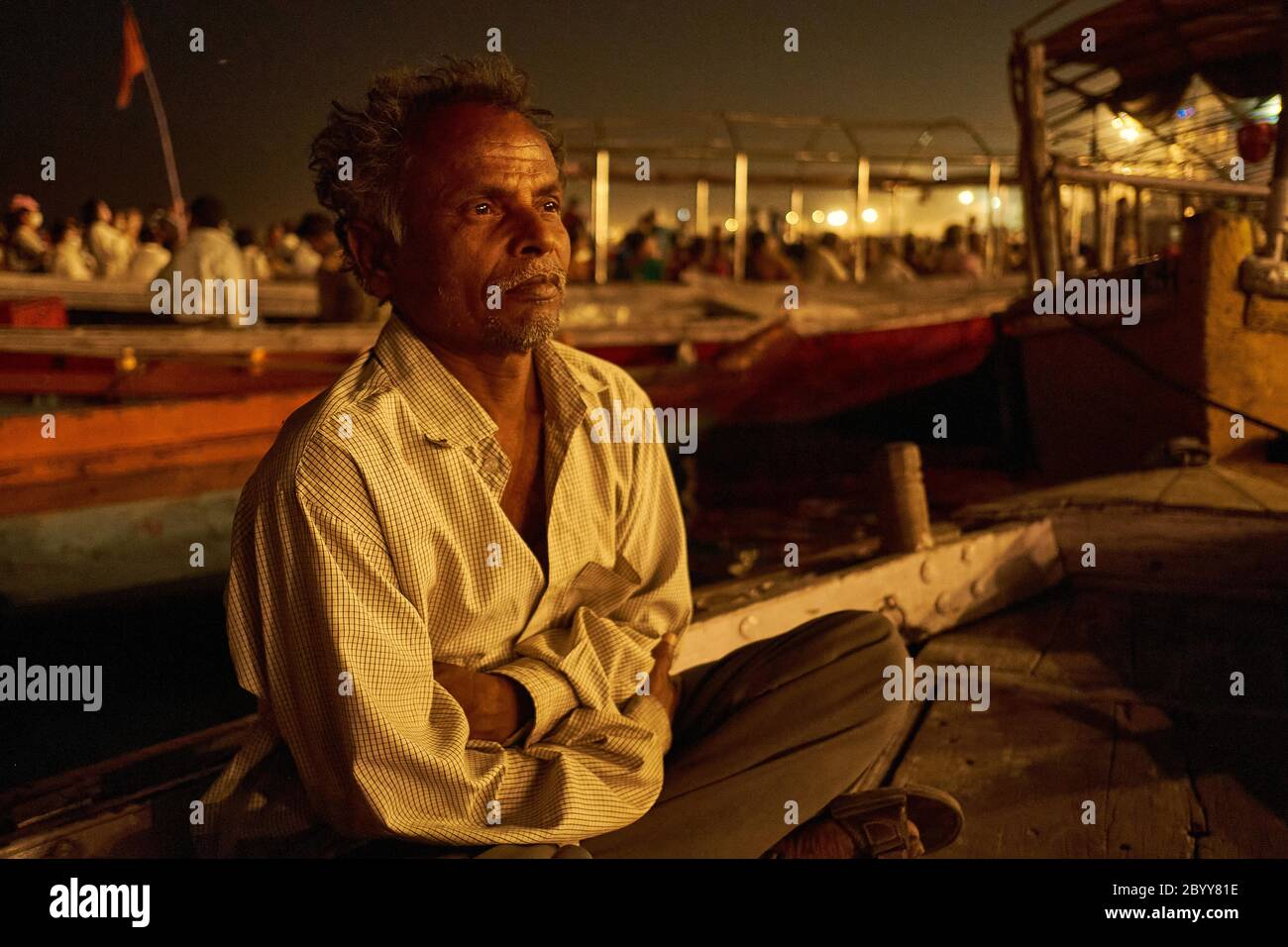 A boatman watches in awe, the ritualistic Ganga Aarti at Dashashwamedh ...