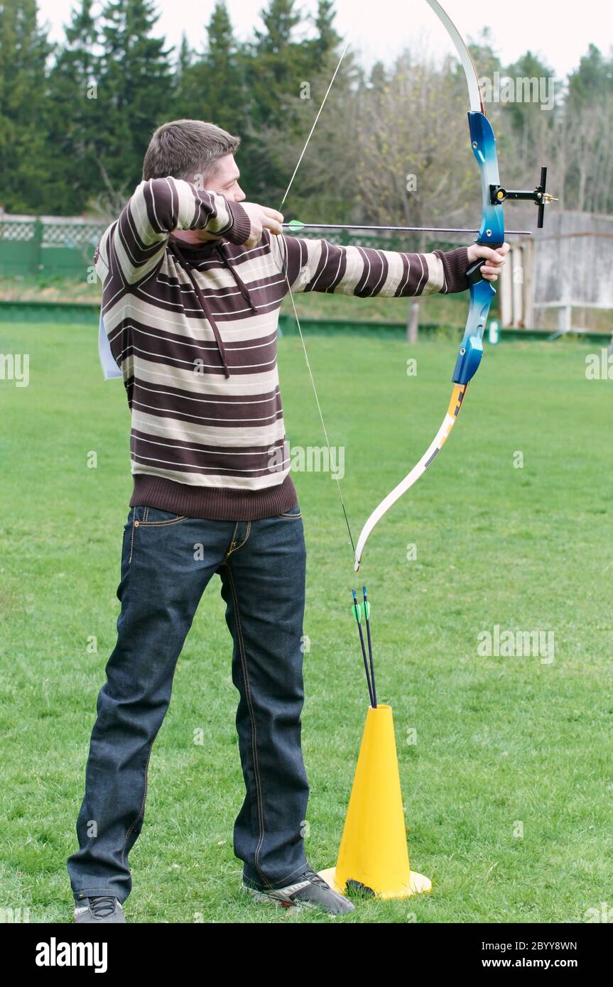 Archer aiming with bow Stock Photo - Alamy