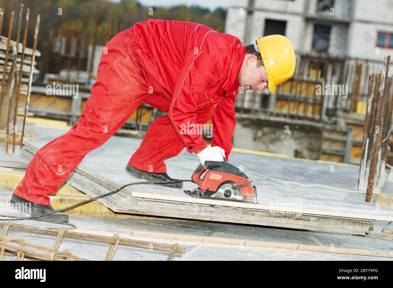 cutting construction wood board with grinder saw Stock Photo - Alamy