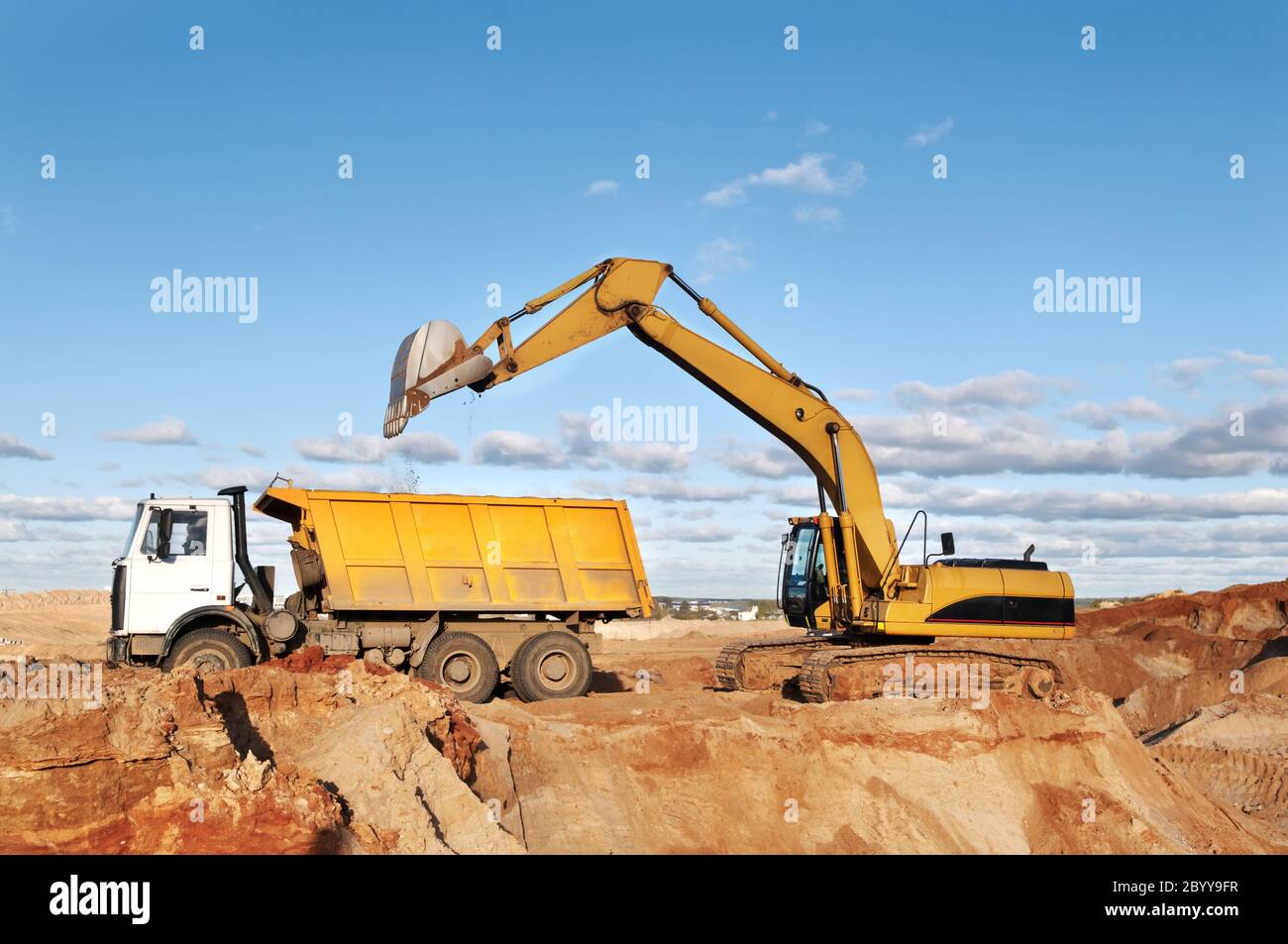 track-type loader excavator and tipper dumper Stock Photo - Alamy