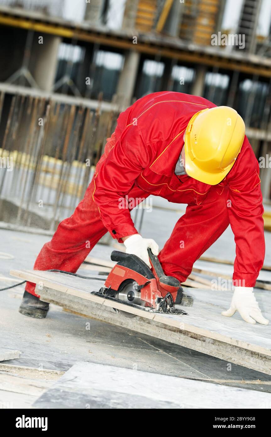 cutting construction wood board with grinder saw Stock Photo - Alamy