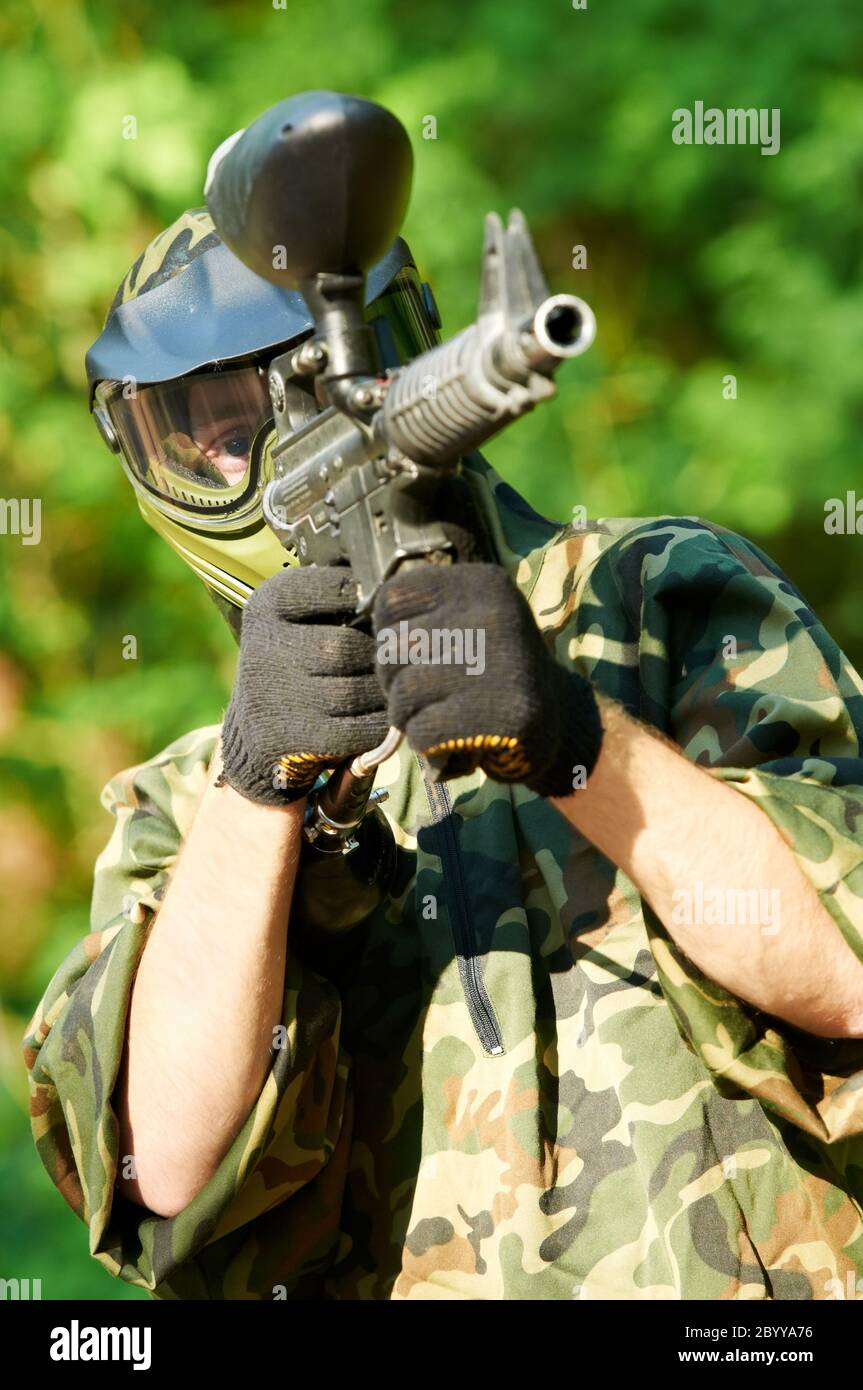 paintball player holding fire Stock Photo - Alamy