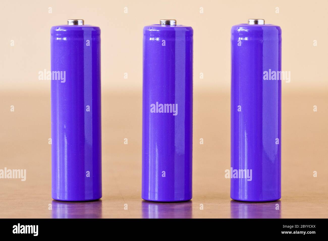 three purple alkaline batteries Stock Photo - Alamy