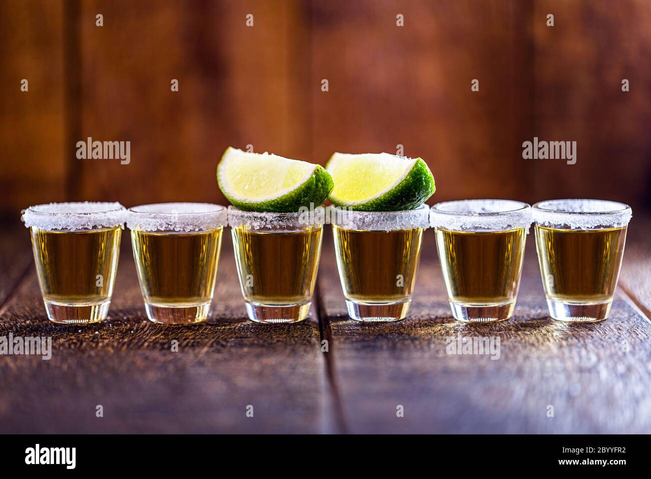 several glasses of tequila lined up, a drink of Mexican culture, made ...