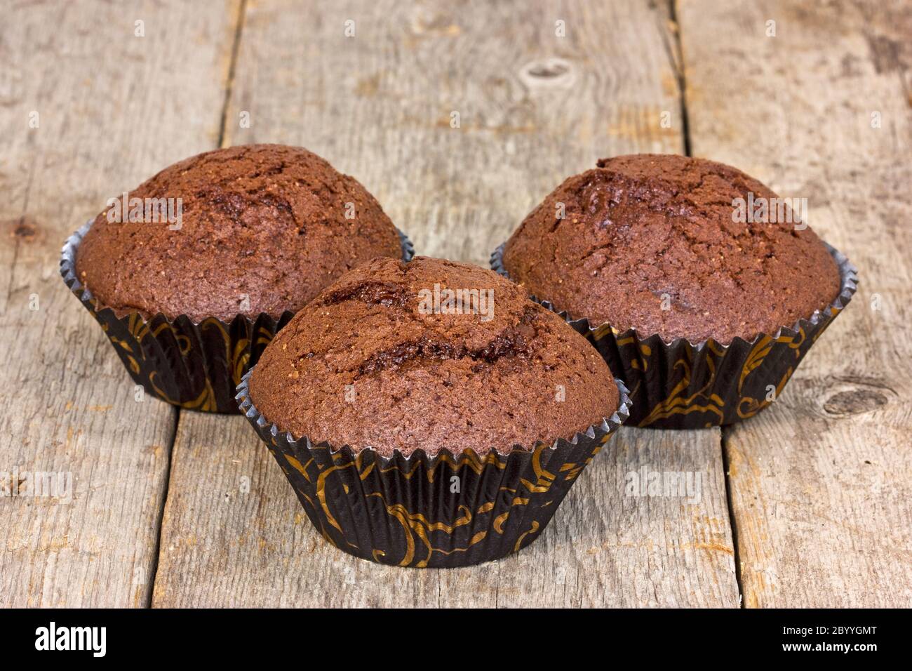 Three chocolate muffins Stock Photo - Alamy