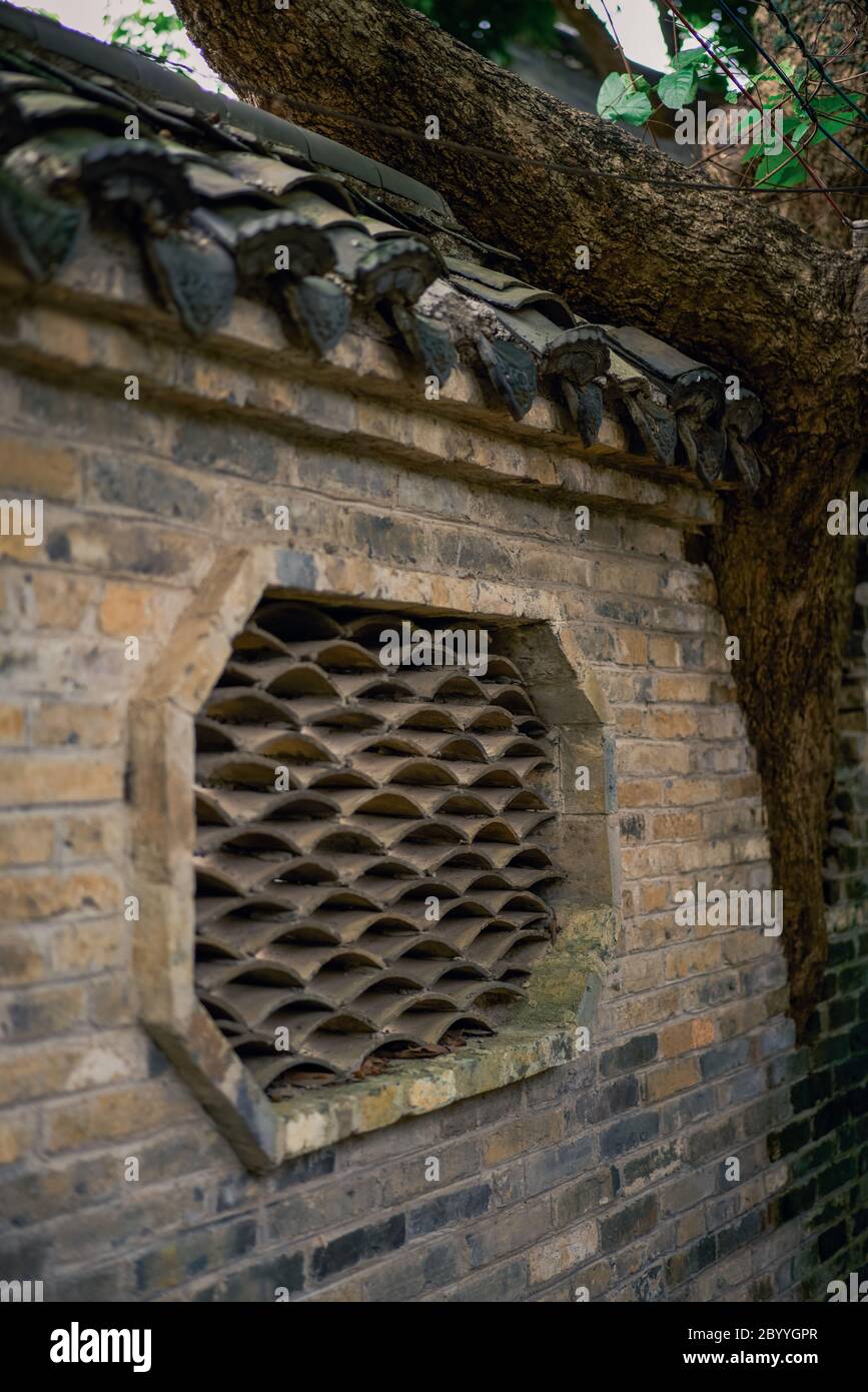 Tiled windows on the external wall of ancient buildings in traditional ...