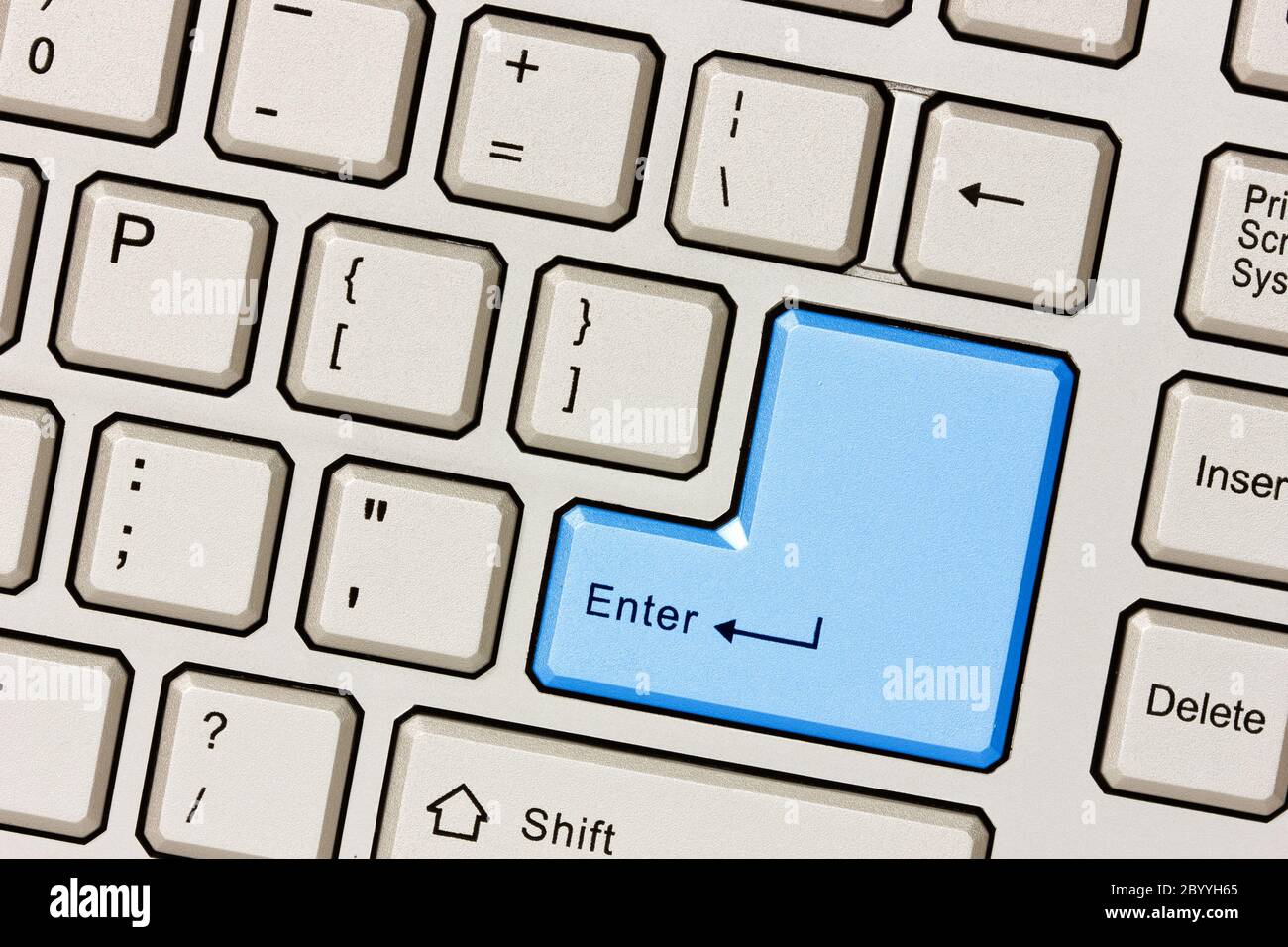 Computer keyboard with blue Enter key Stock Photo - Alamy