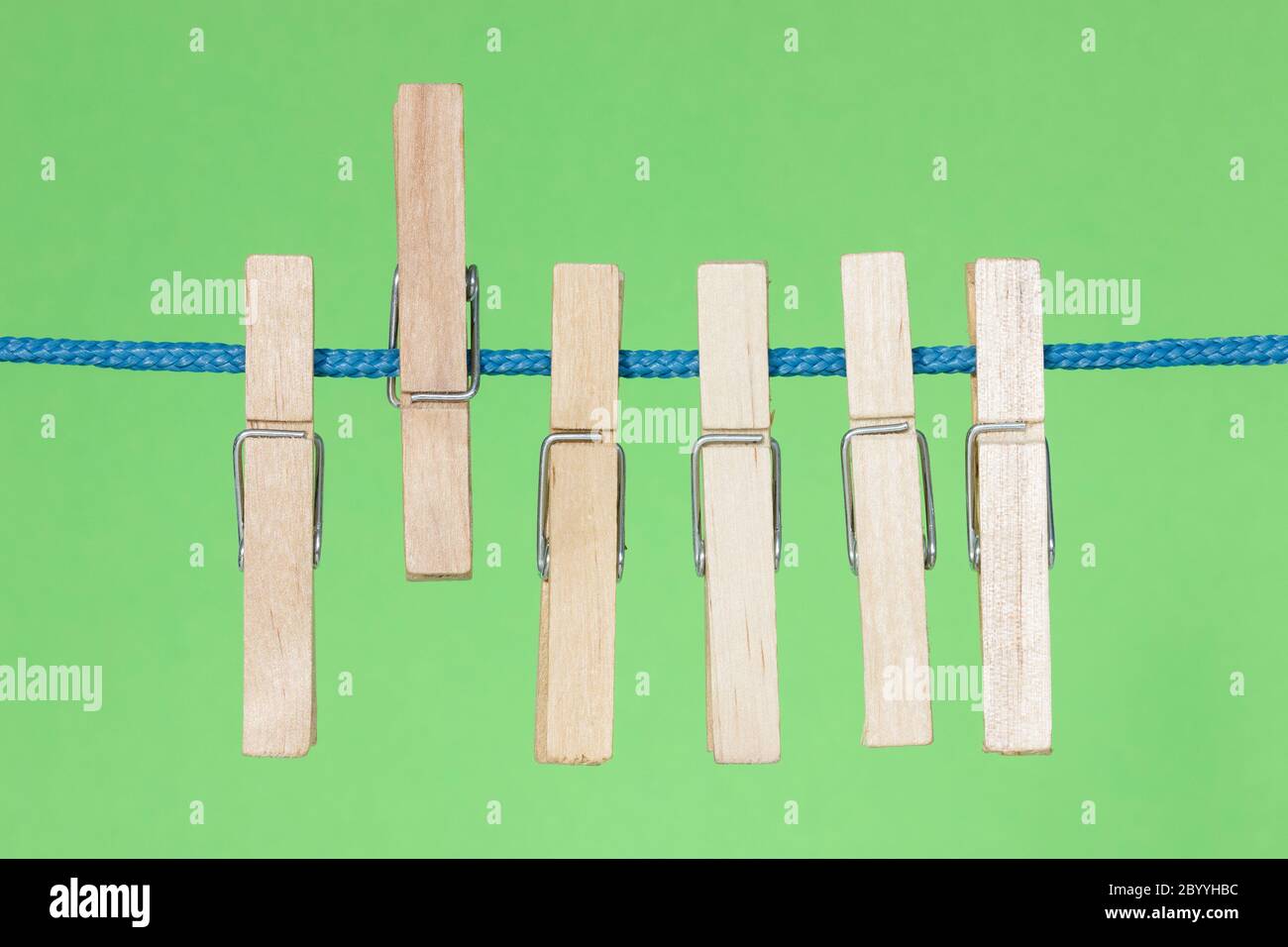 Clothes pegs on the green background Stock Photo - Alamy