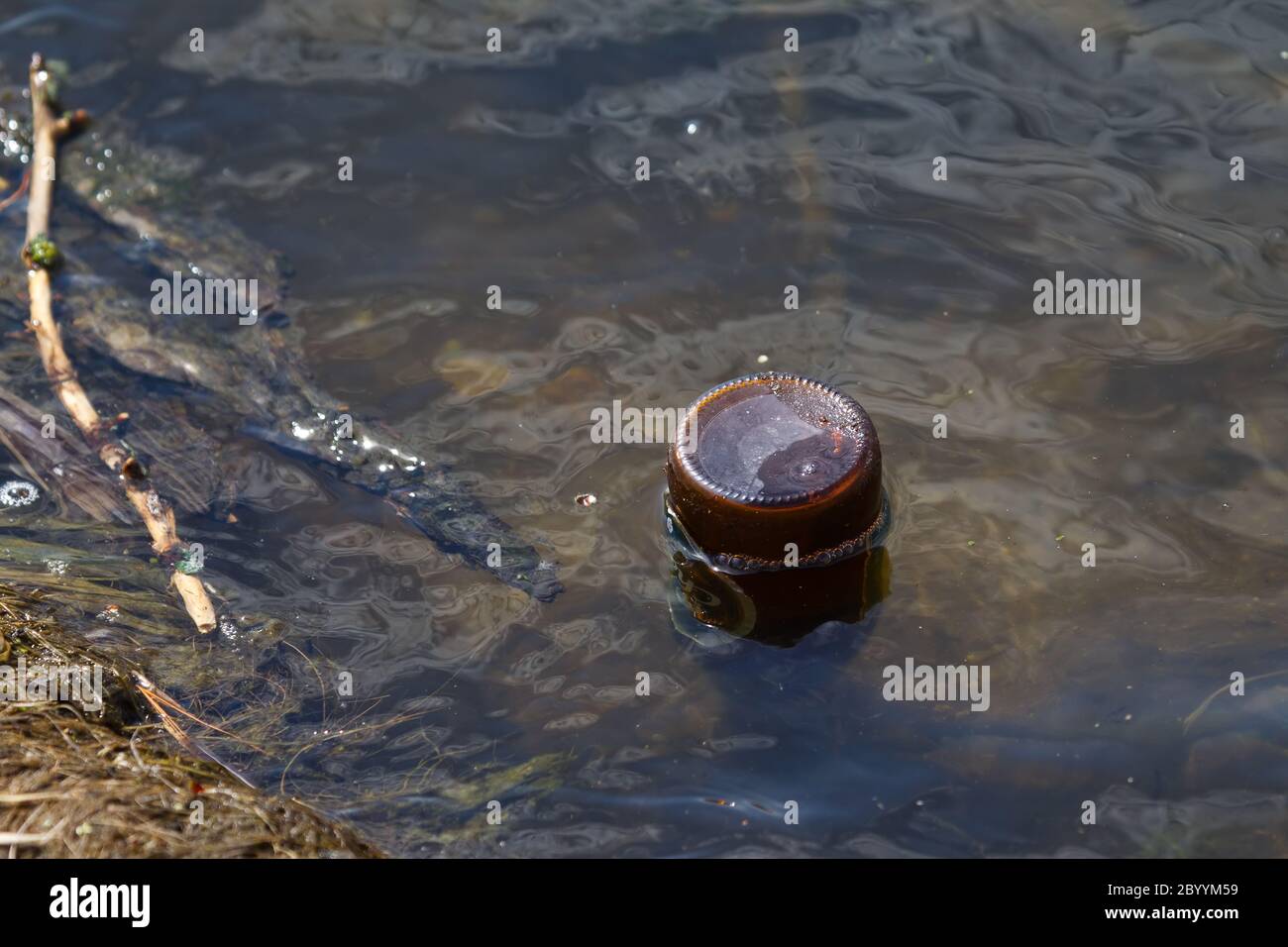 Bottle floating in a pond Stock Photo - Alamy