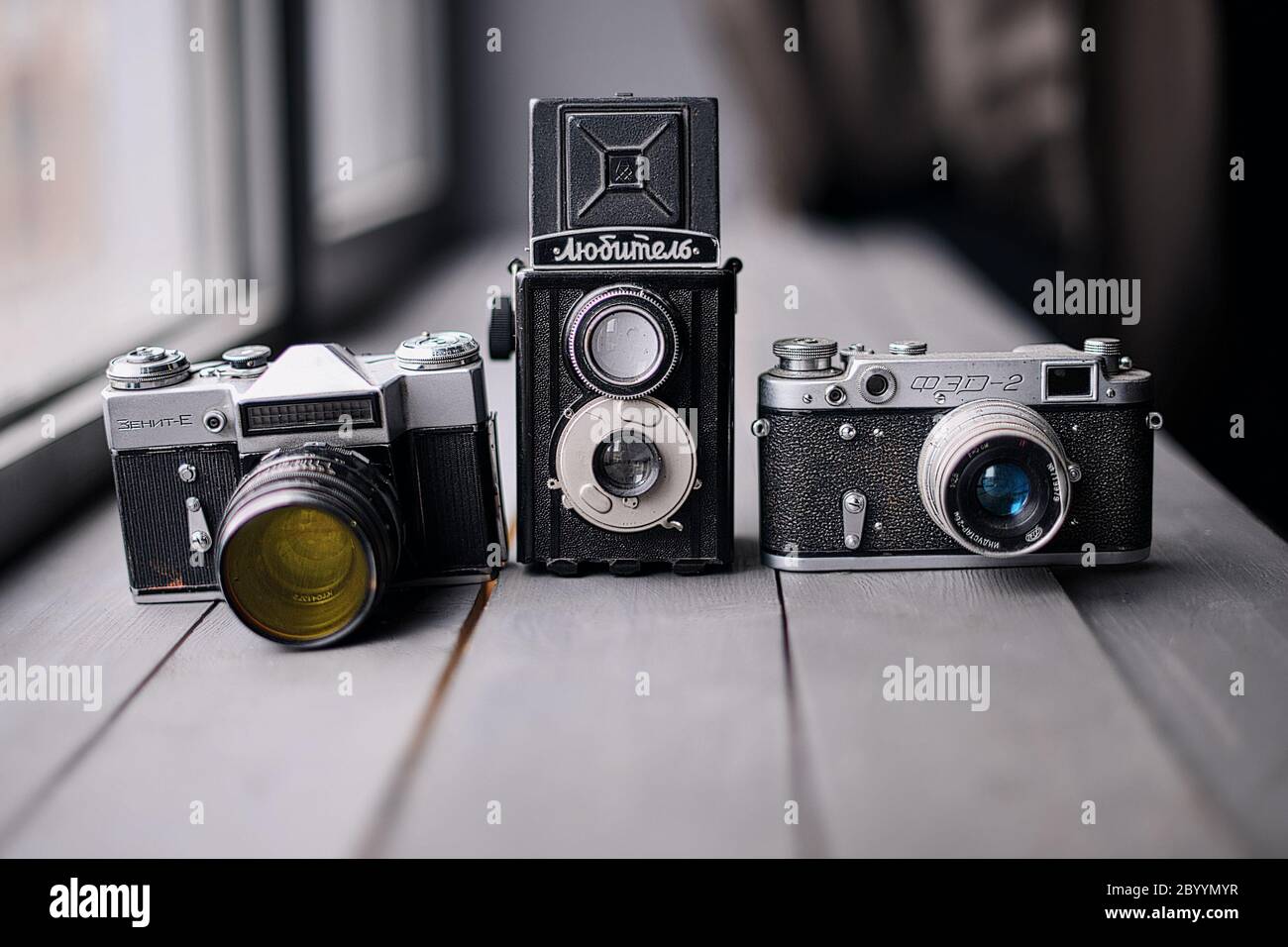 Three Old Reflex Cameras Isolated On Wooden Background vintage twin ...