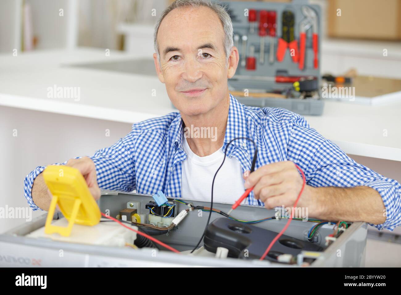 senior engineer measuring multimeter panel board Stock Photo - Alamy