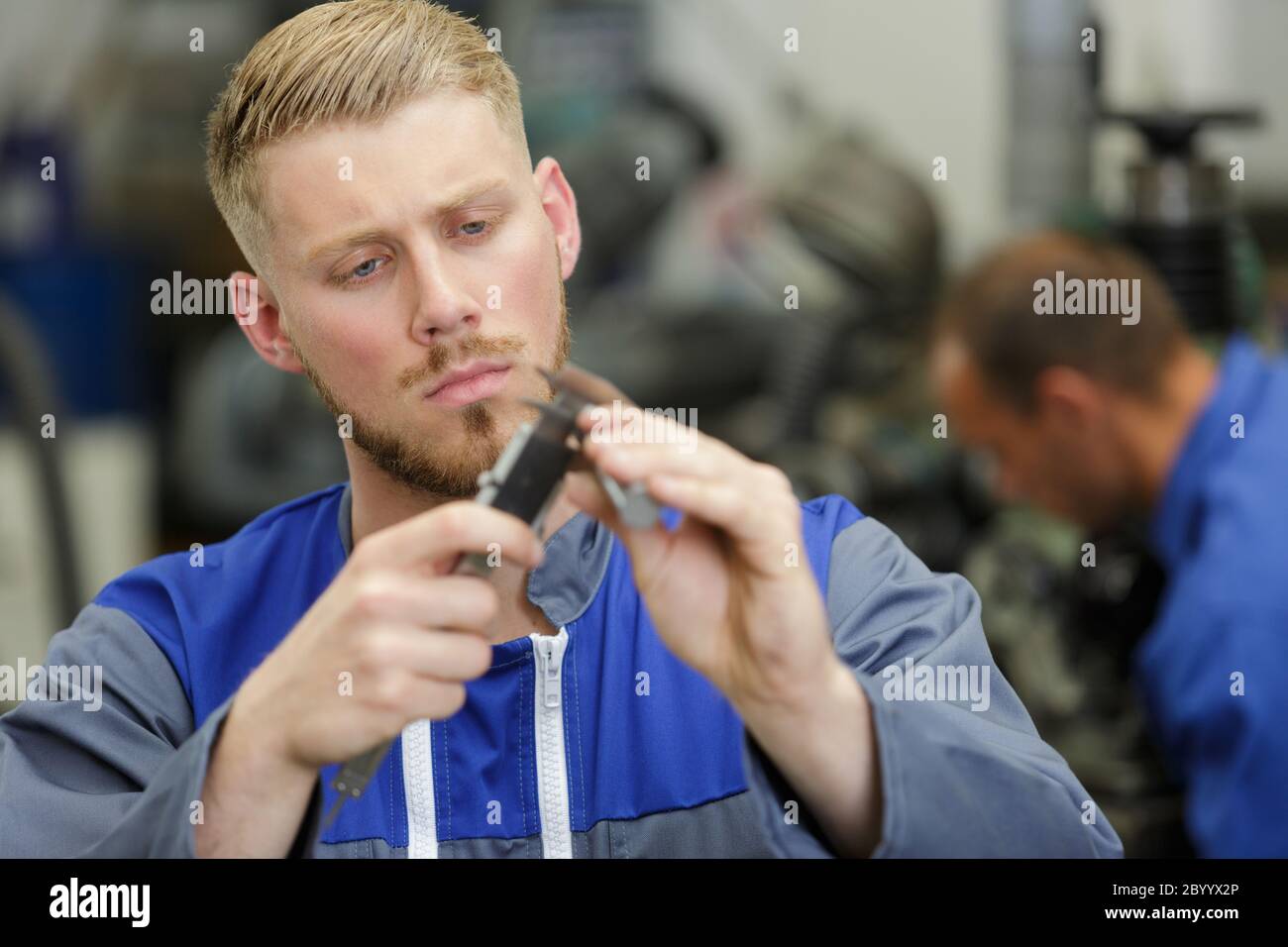 an apprentice using vernier gauage Stock Photo - Alamy