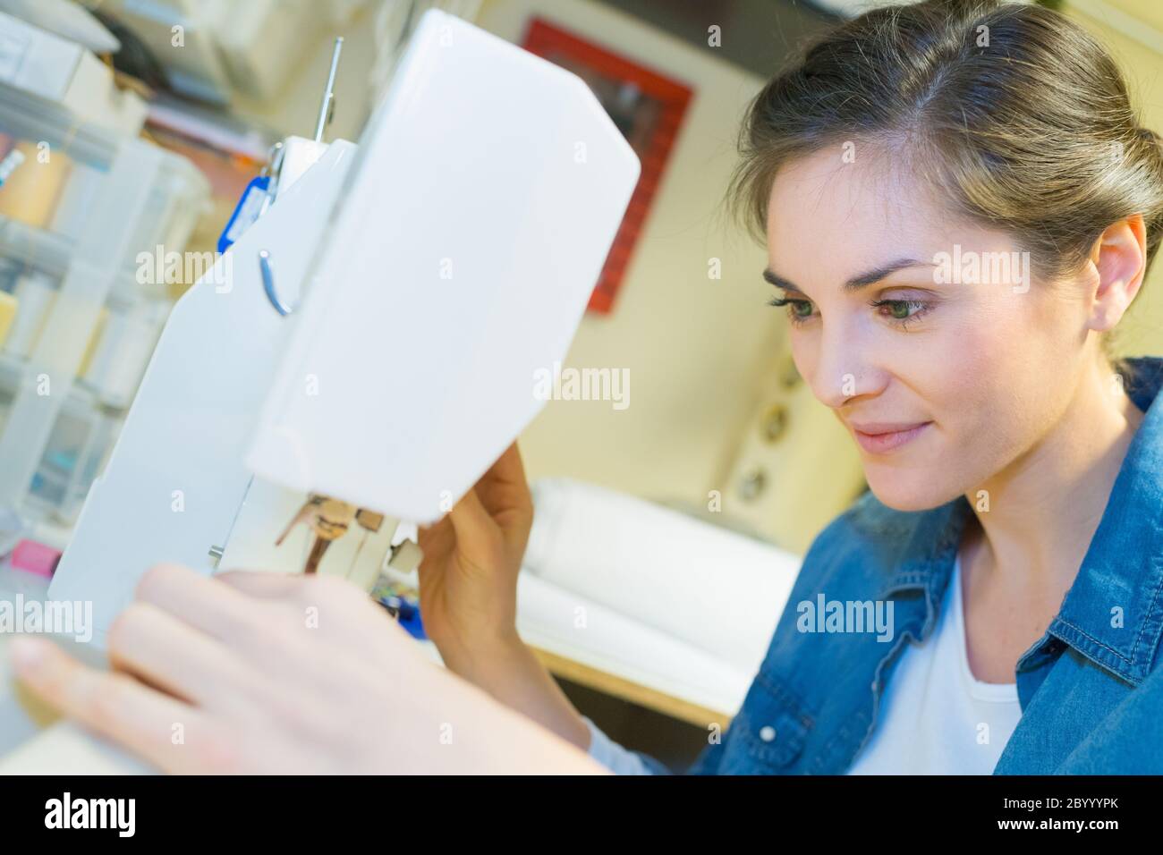 young woman sewing with sewing machine Stock Photo - Alamy