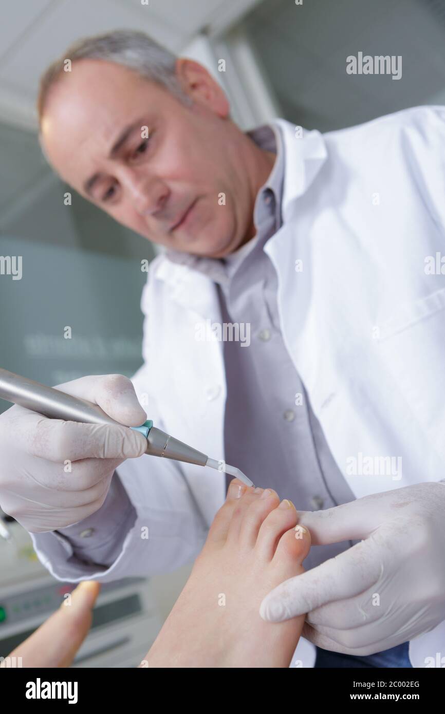 the doctor-podiatrist does an examination of the patients foot Stock ...