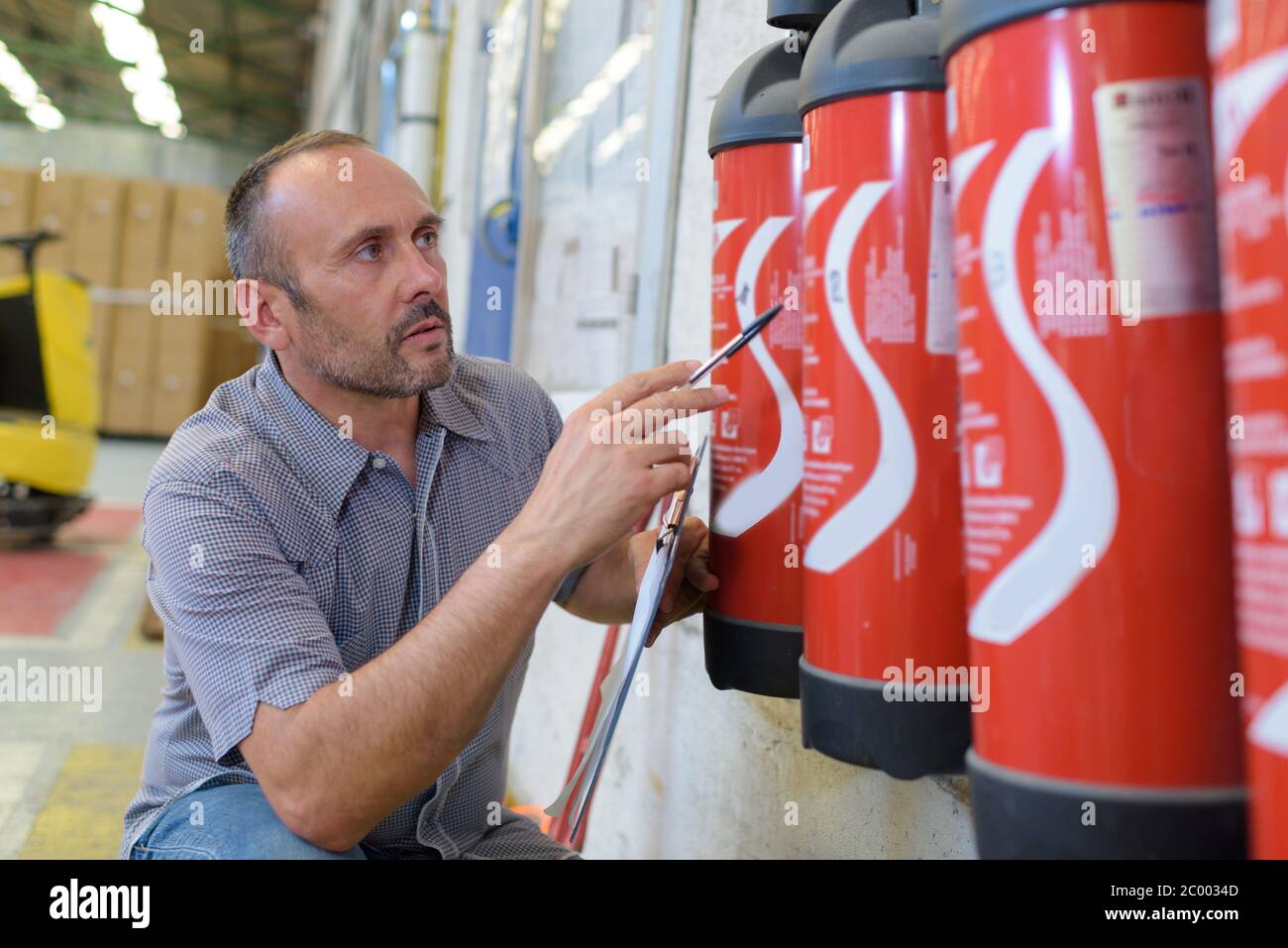 Man using fire extinguisher hi-res stock photography and images - Alamy