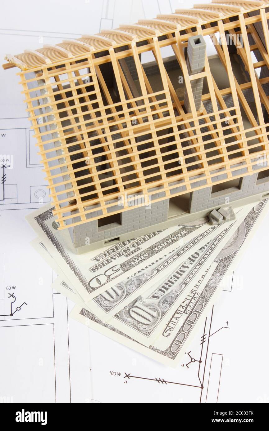 Small house under construction and currencies dollar on electrical ...