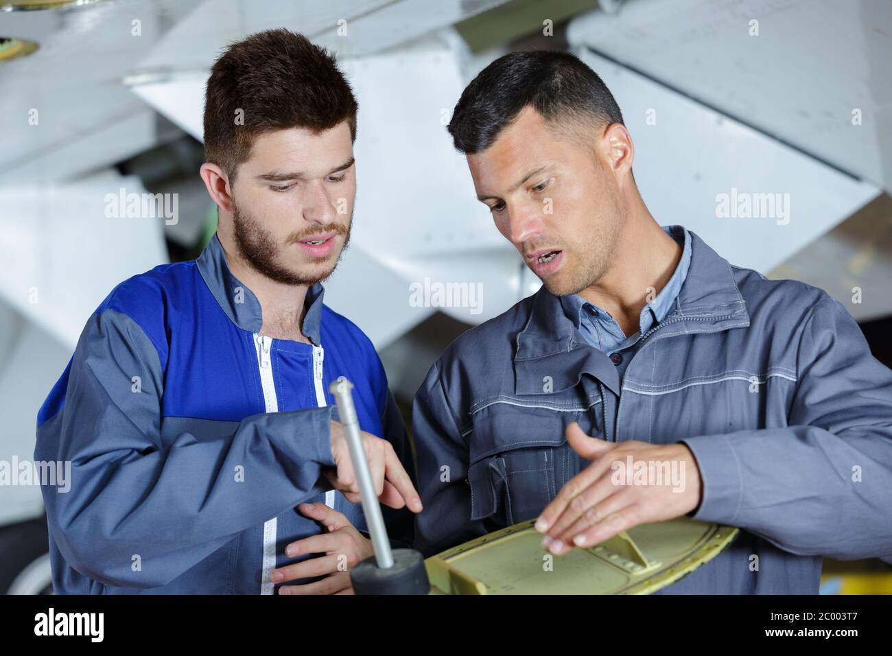 engineer and apprentices fixing airplane propellers Stock Photo - Alamy