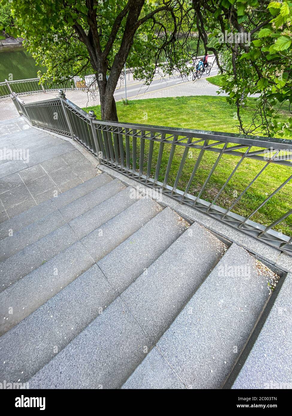 stone-paved staircase down in the summer park. stone stairway near ...