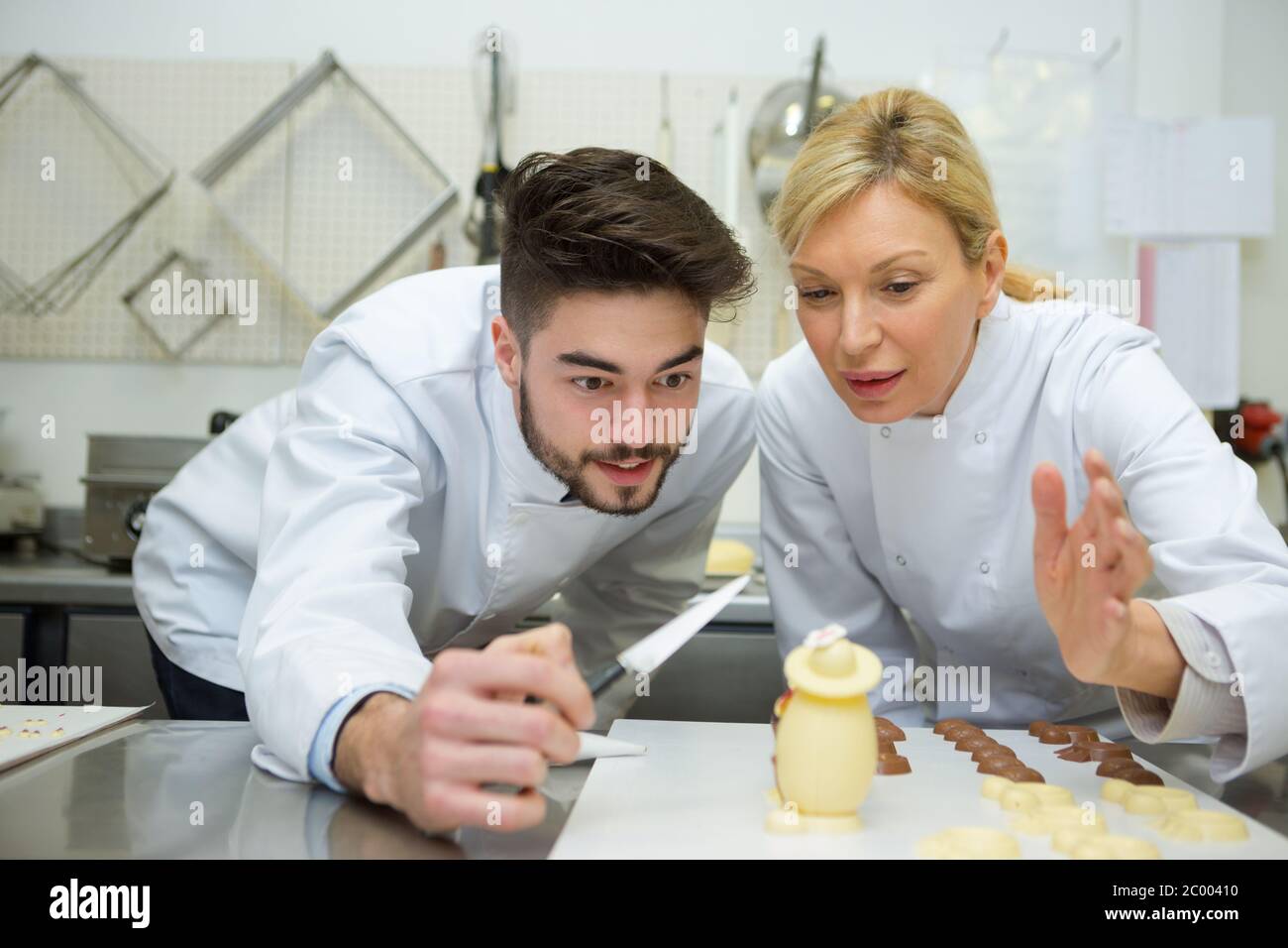 cretaive chefs making figure from chocolate Stock Photo - Alamy