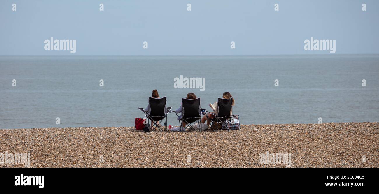 Reading quietly by the sea Stock Photo - Alamy
